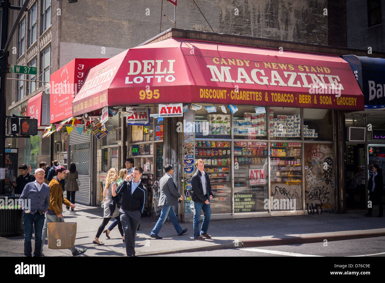 A corner deli in a taxpayer on Sixth Avenue in Midtown Manhattan in New ...