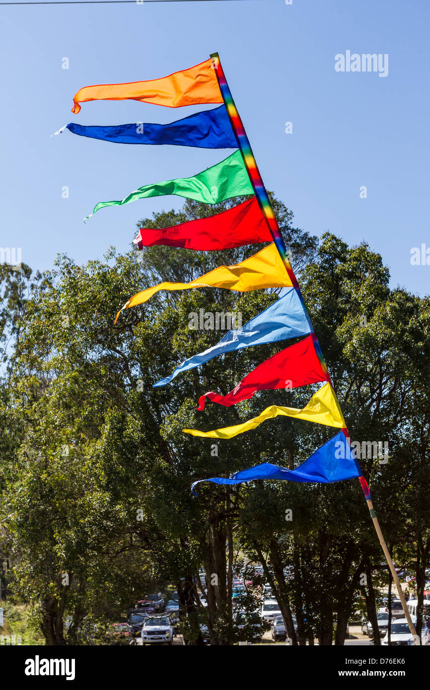 Coloured flags flying against bright blue sky Stock Photo - Alamy
