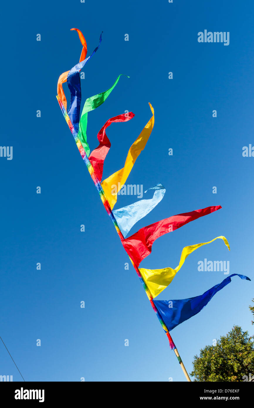 Coloured flags flying against bright blue sky Stock Photo - Alamy