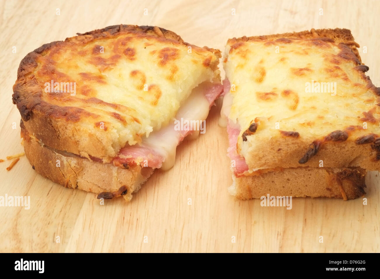 A toasted and cut open Croque Monsieur sandwich with melted cheese and ...