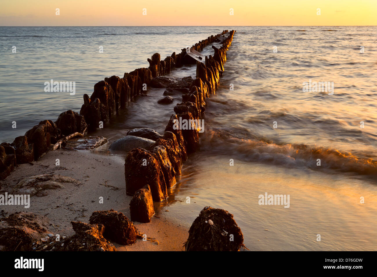 old breakwater in North sea at sunset with long exposure Stock Photo ...