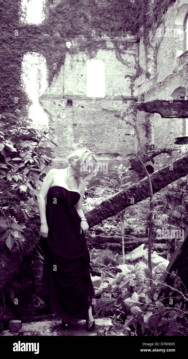 Beautiful blond dressed elegantly looking vulnerable in a desert place ...