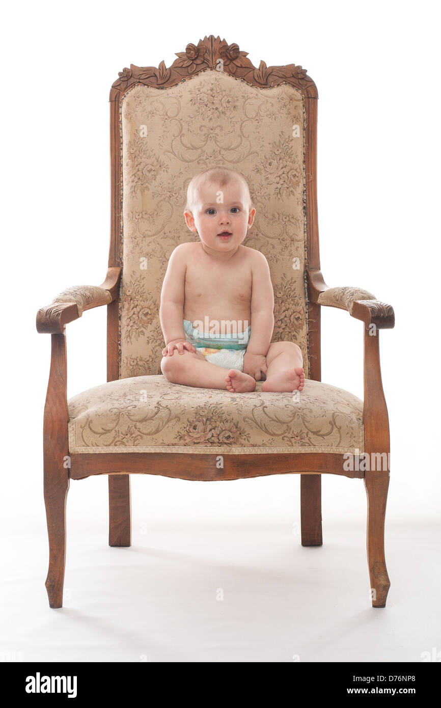 Little boy sits on the retro chair Stock Photo - Alamy
