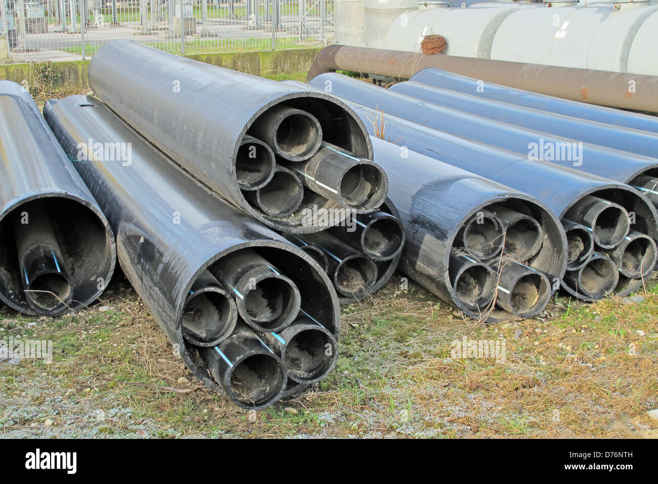 piles of plastic pipes and conduits for transporting water and gas ...