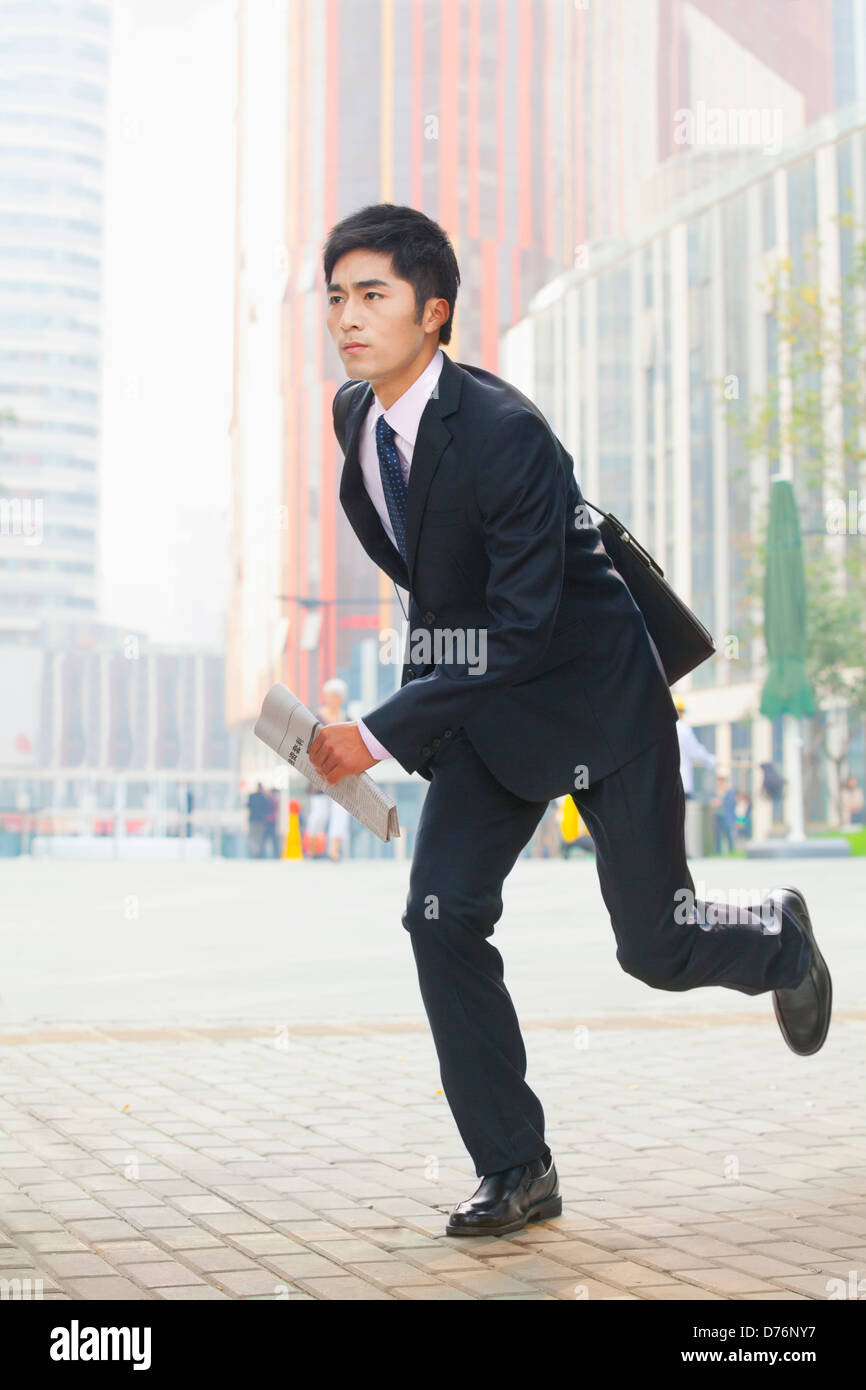 Businessman running, Beijing, China Stock Photo - Alamy