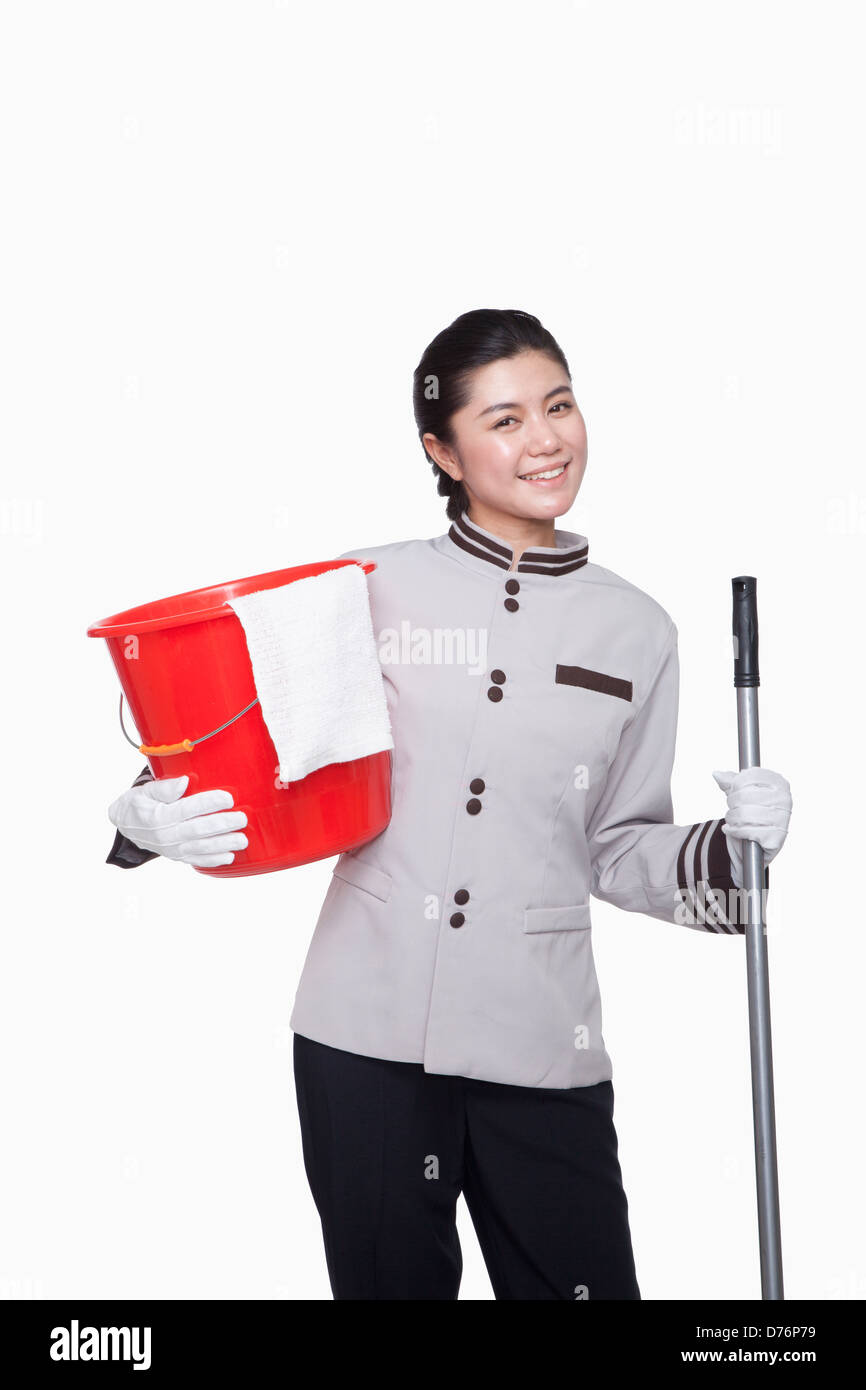 Young female caretaker with bucket and mop, studio shot Stock Photo - Alamy