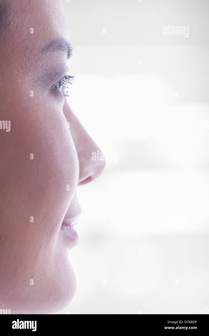 Side view of woman's face on bright background Stock Photo - Alamy