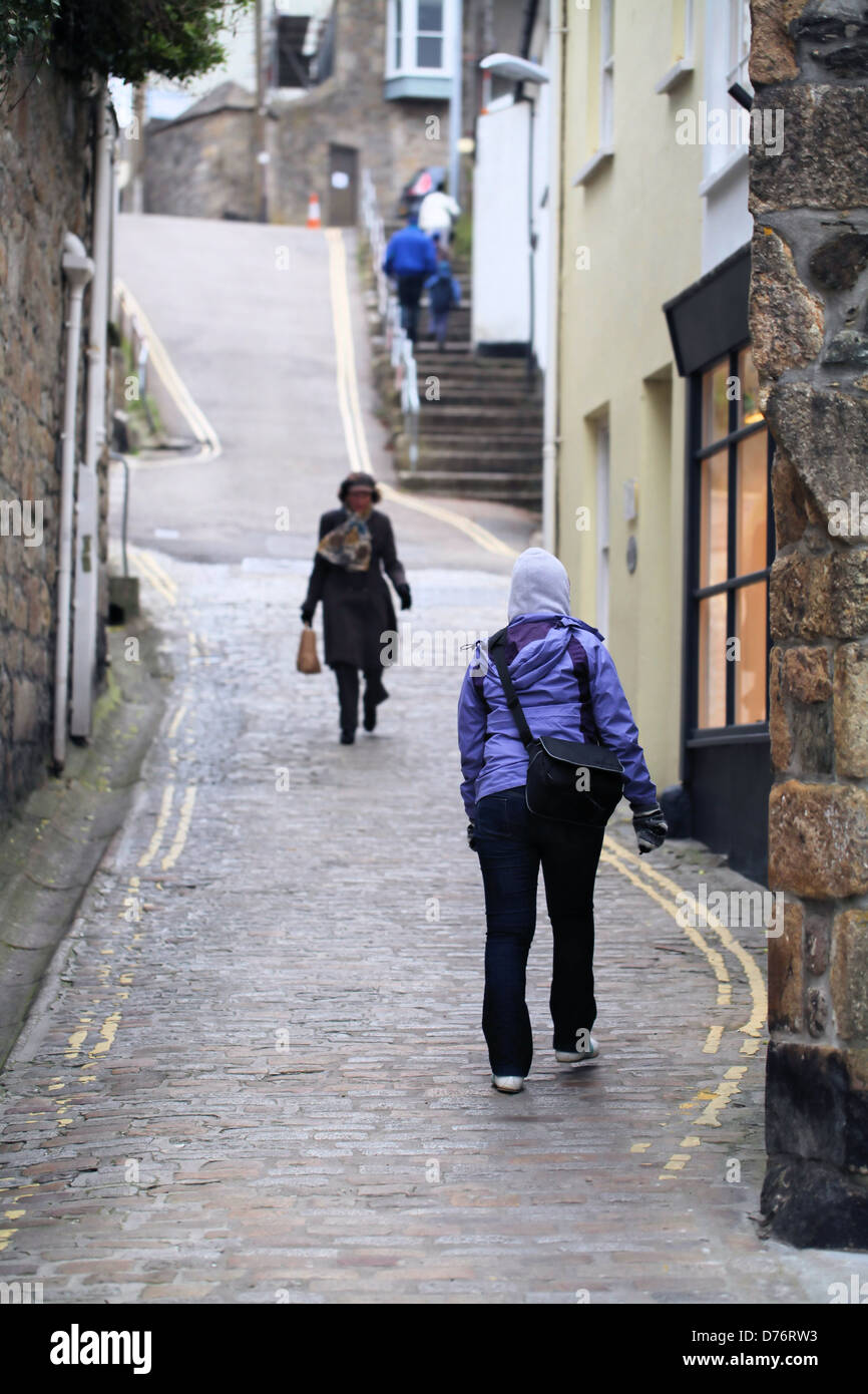 Woman walking up steep hill hi-res stock photography and images - Alamy
