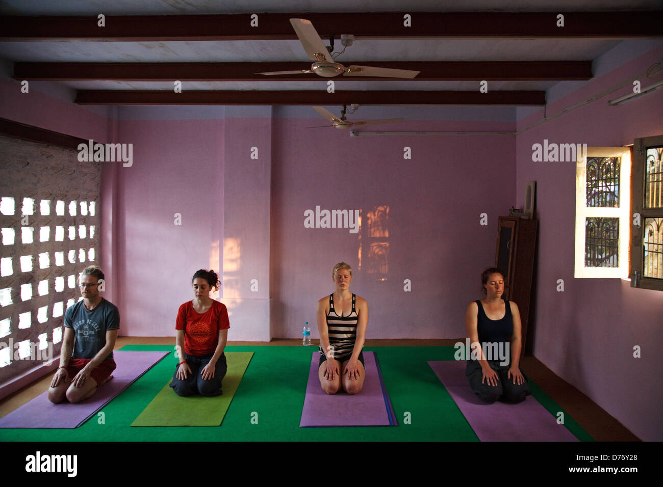 Foreigners practising yoga in a yoga school in Varanasi, India Stock ...