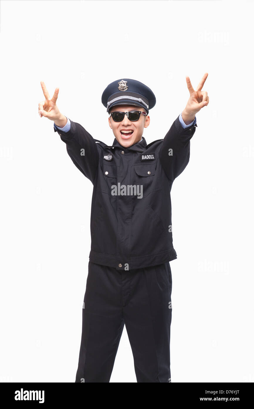Police Officer Giving Peace Sign, Studio Shot Stock Photo - Alamy