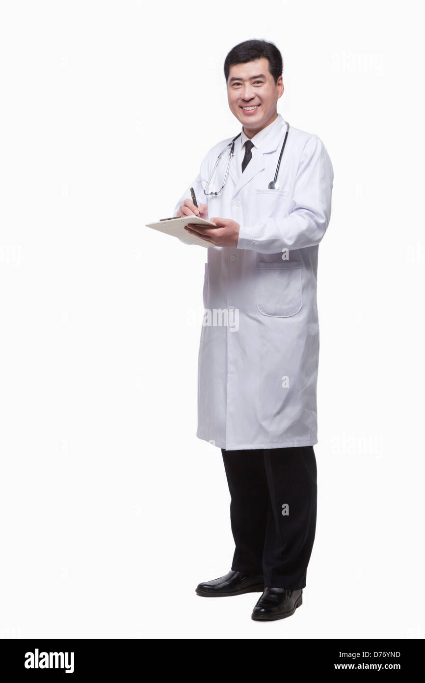 Full Length Portrait of Doctor Writing Medical Record Stock Photo - Alamy