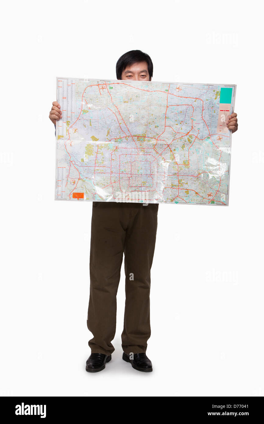 Man holding map Stock Photo - Alamy