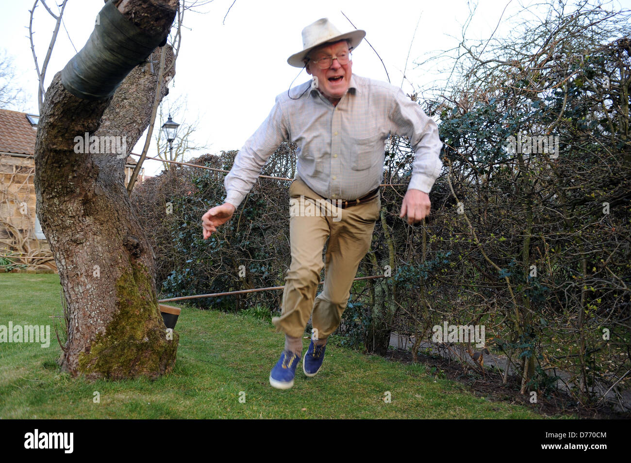 74 year old grandfather jumping around an obstacle course in the family ...