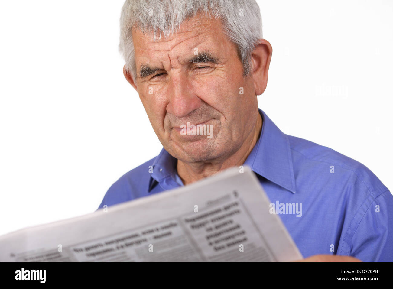 Senior reading a newspaper on a white background Stock Photo - Alamy