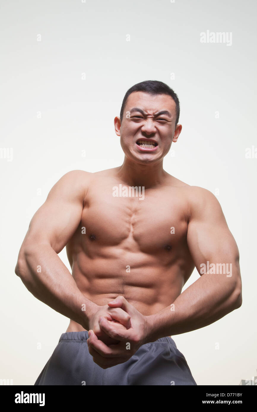 Muscular Man Growling and Flexing Shirtless Stock Photo - Alamy