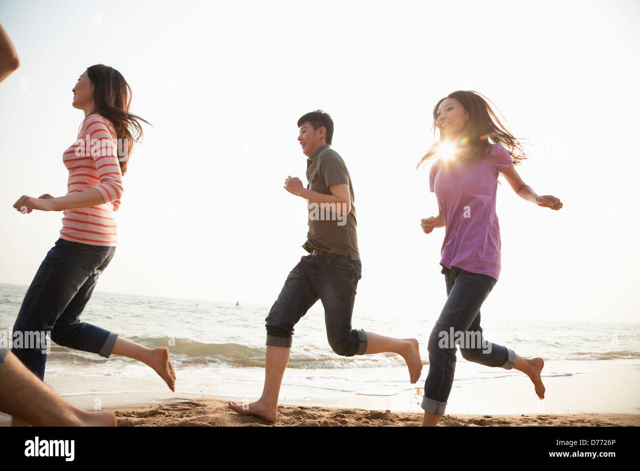 Friends Running at the Beach Stock Photo - Alamy