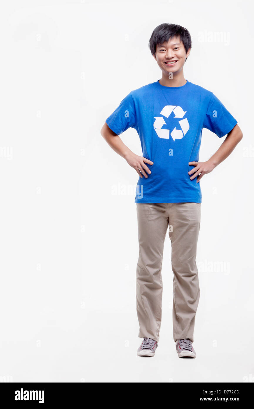 Portrait of young man wearing recycling symbol T-shirt, studio shot ...