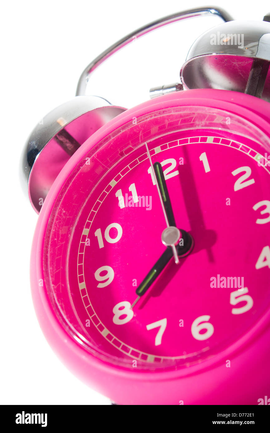 Retro Pink alarm clock tilted and isolated on white Stock Photo - Alamy