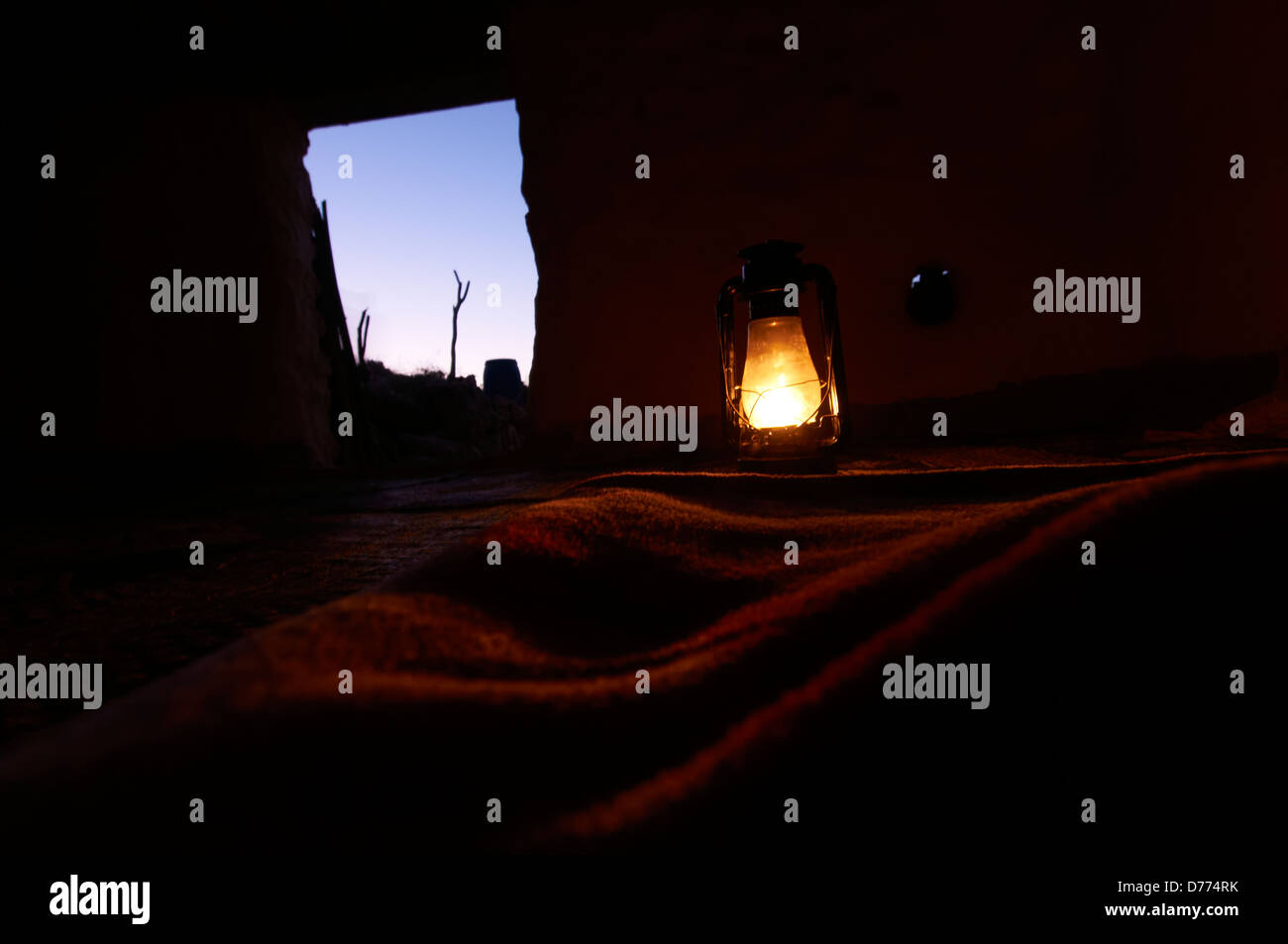 A lantern glowing in the night fall in a local home on the island of ...