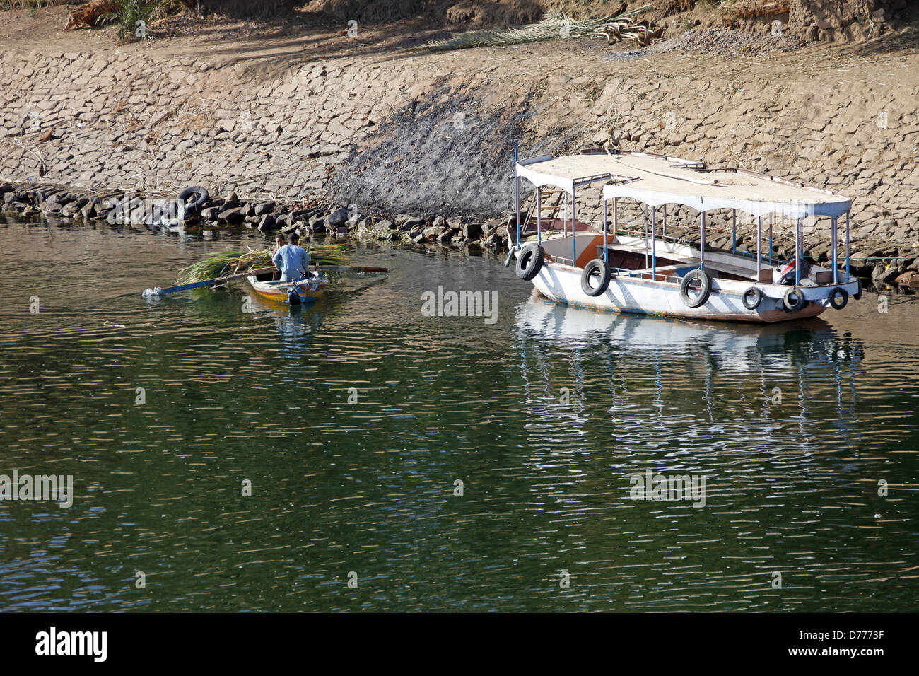 MUSLIM MAN & BOY IN ROWING BOAT RIVER NILE EGYPT 09 January 2013 Stock ...