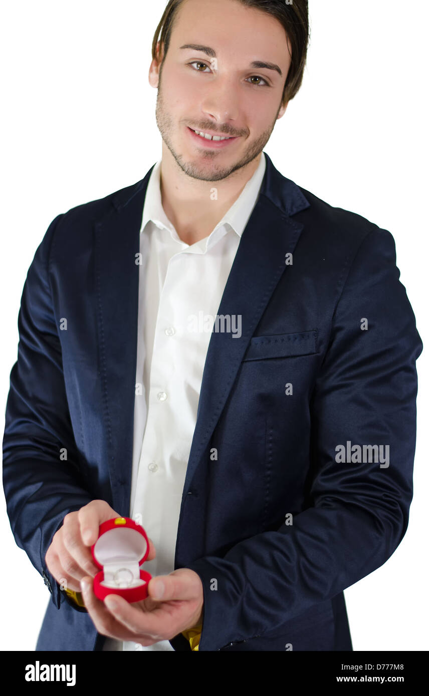 Handsome young man with engagement ring box in his hands, isolated on ...