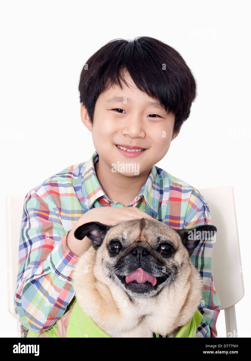 Portrait of Boy holding pet pug Stock Photo - Alamy