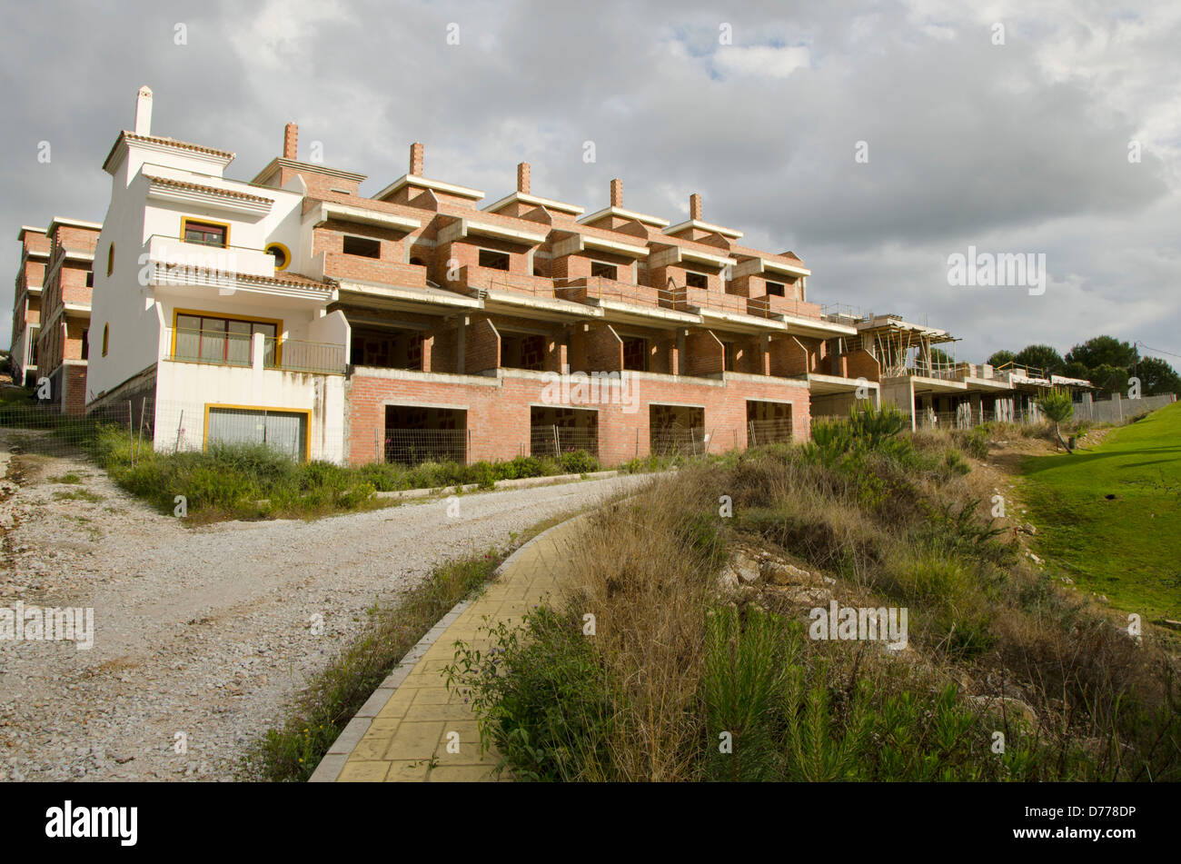 Unfinished town houses next to golf course in Spain Stock Photo - Alamy