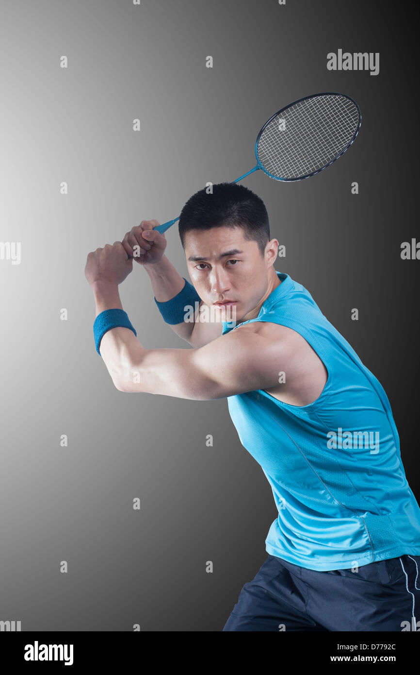 Young man playing badminton, racket raised Stock Photo - Alamy