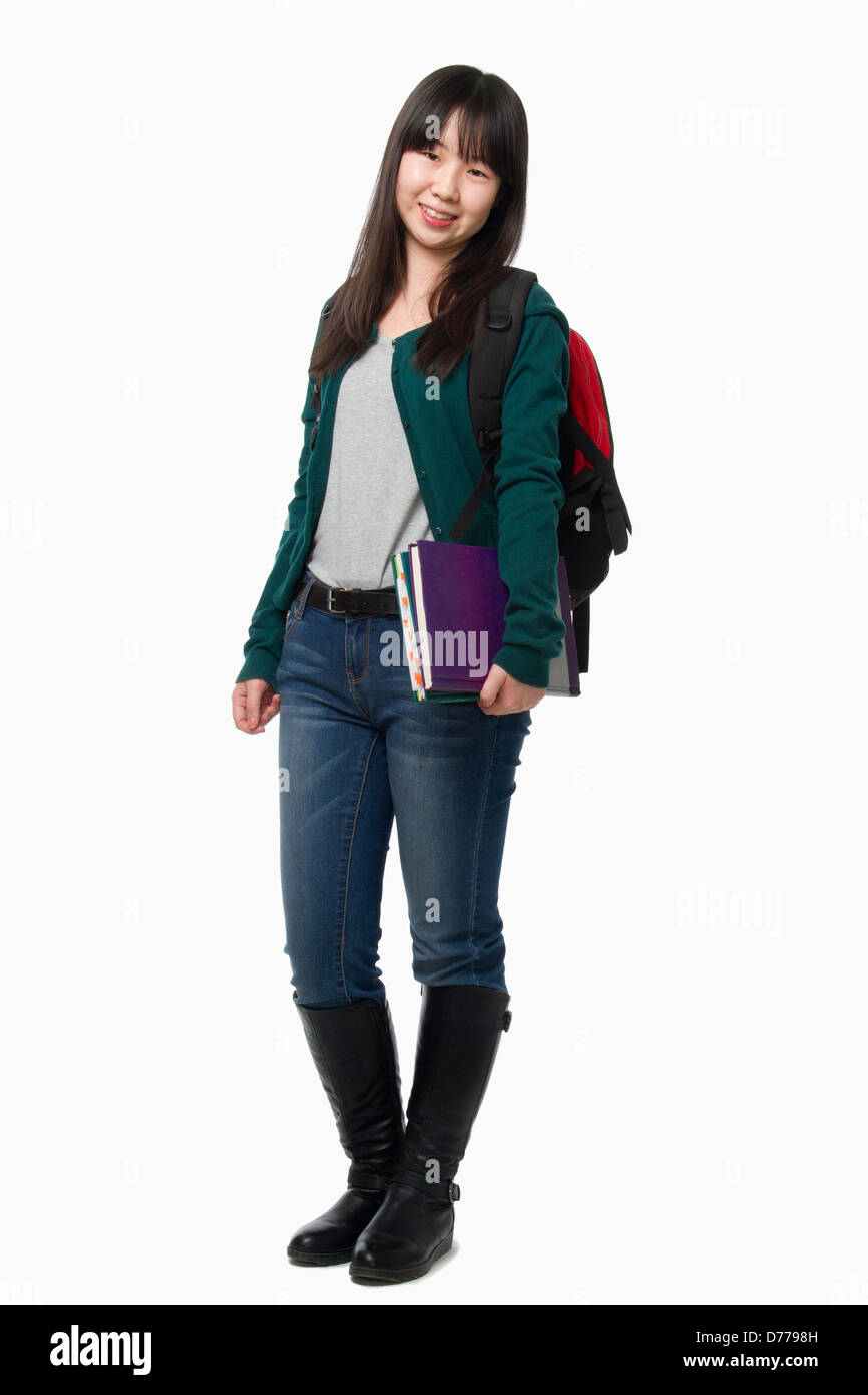 Smiling female student carrying books, portrait Stock Photo - Alamy