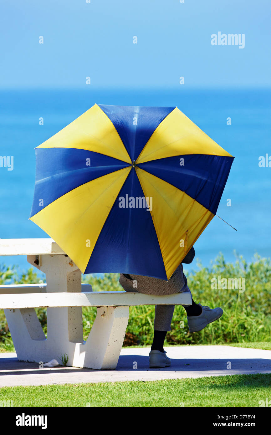 Man Under Sun Umbrella Stock Photo - Alamy