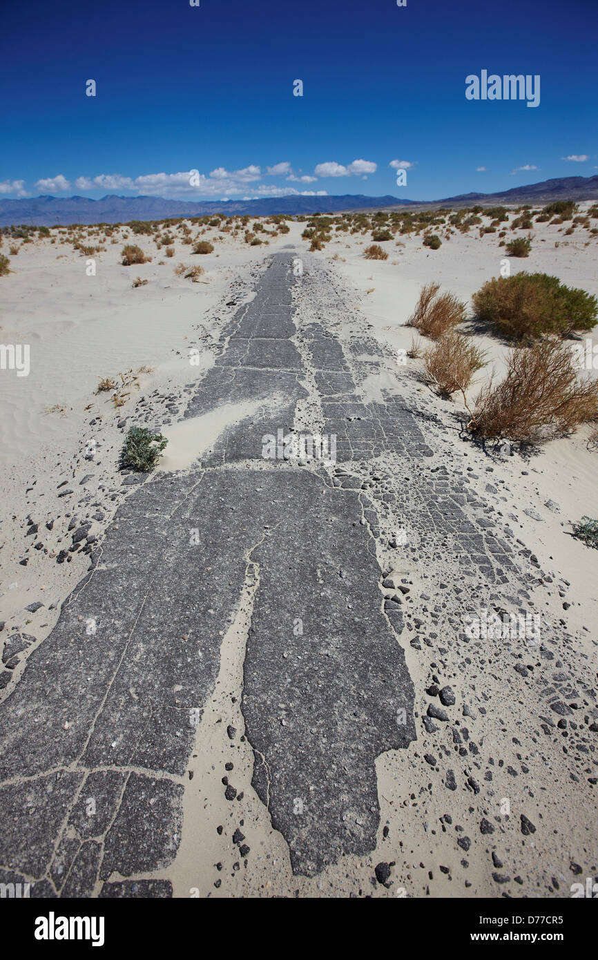 Sand dunes overtaking old paved road Olancha Dunes near Olancha ...
