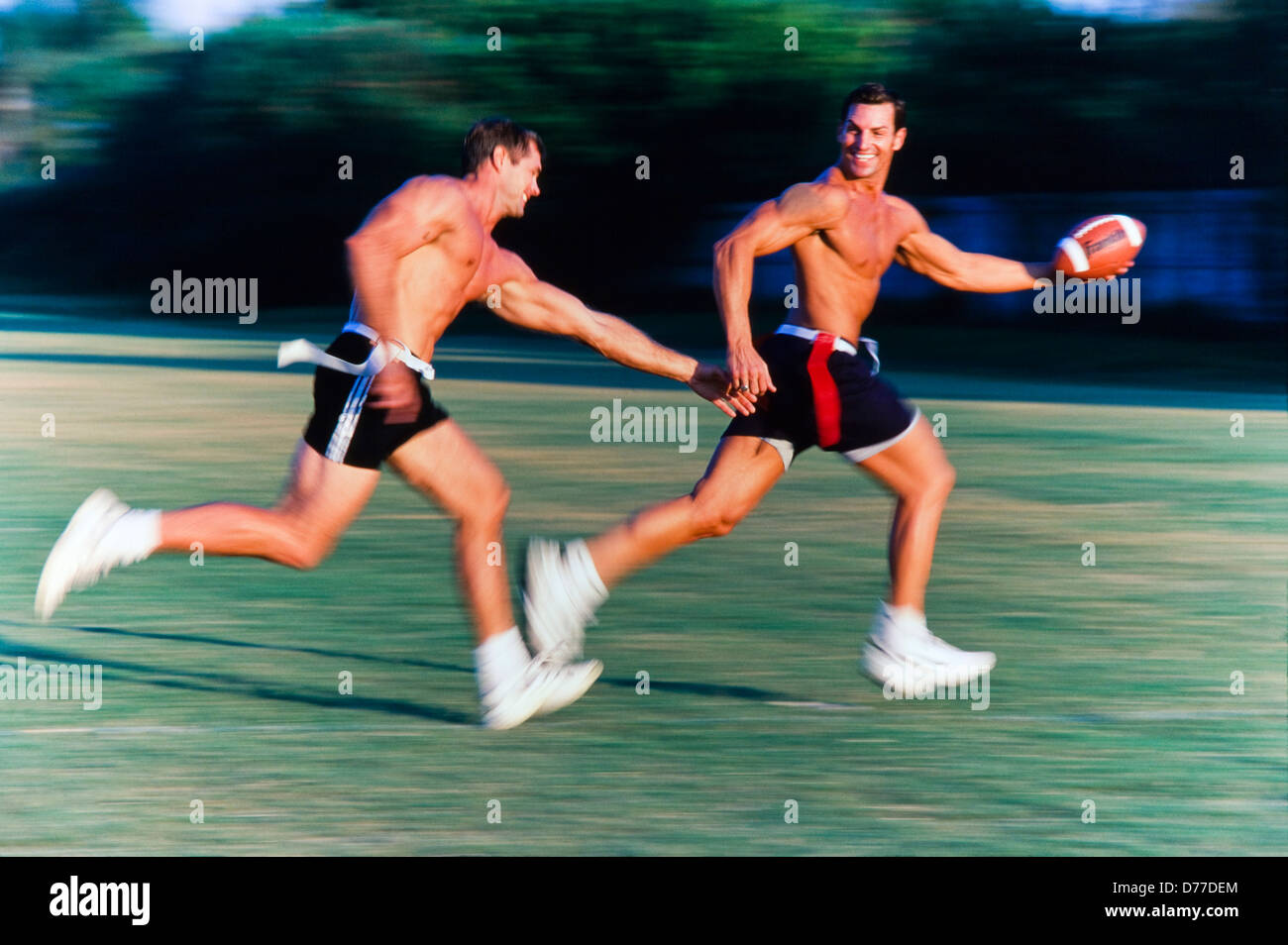 Men playing football, Taunting, team competition, sunny afternoon game ...