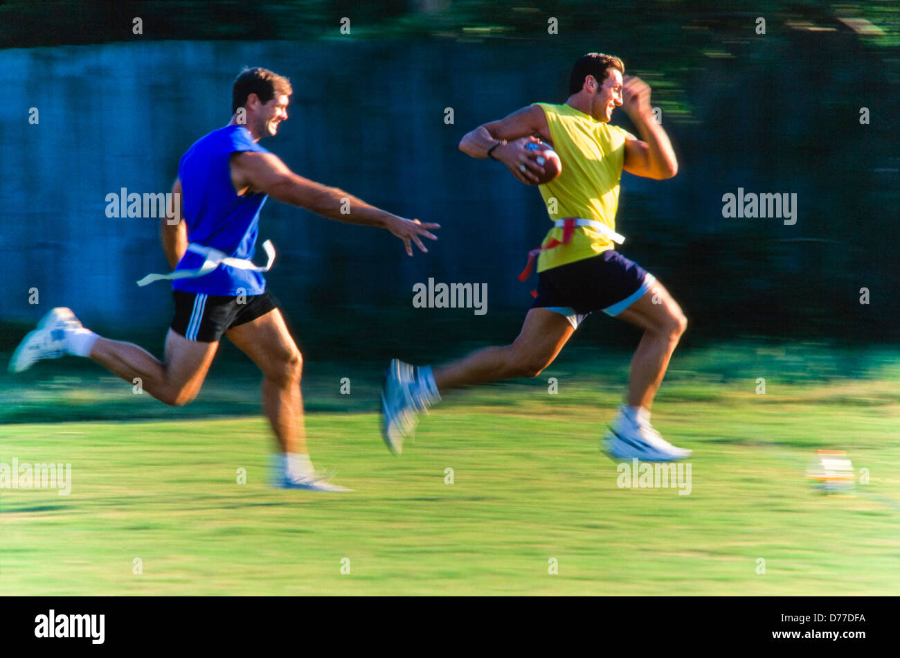 Men playing football, running and motion effects, team competition ...