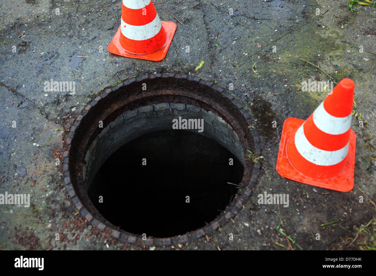 Open manhole cover with cone Stock Photo - Alamy