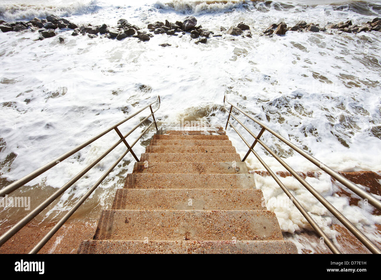 Concrete stairs leading to base sea wall breaking surf Galveston ...