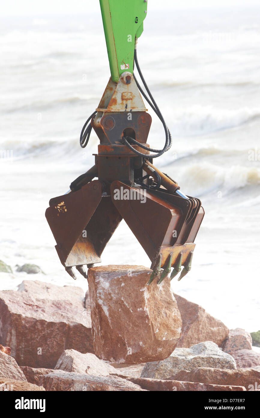 Clamshell grapple moving large boulders Galveston Seawall Galveston ...