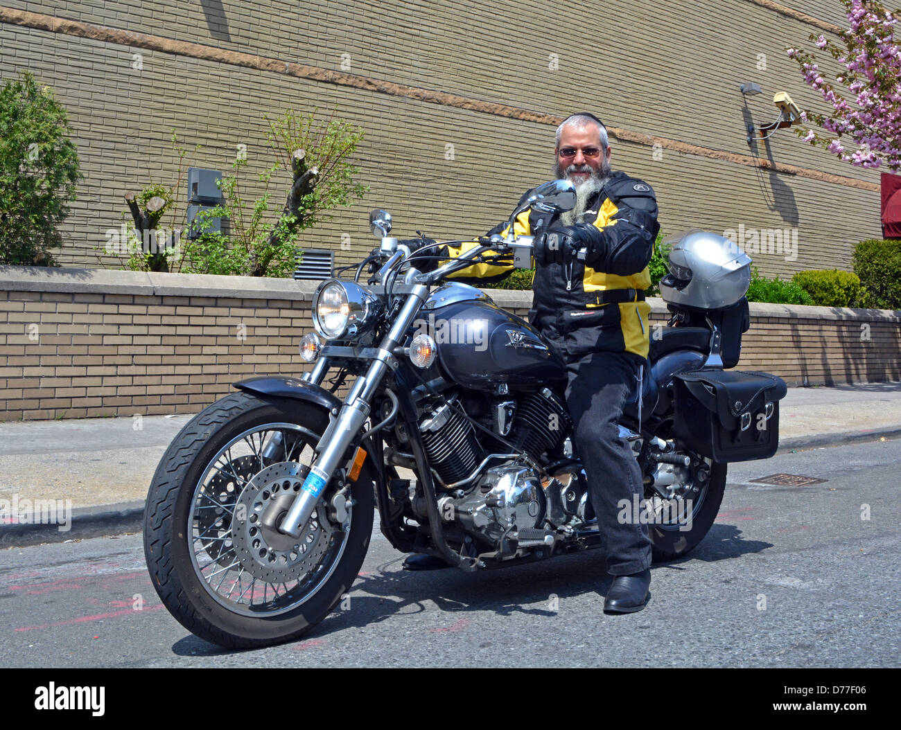 Religious Jewish man on a motorcycle at the Lag B'Omer parade in Crown ...