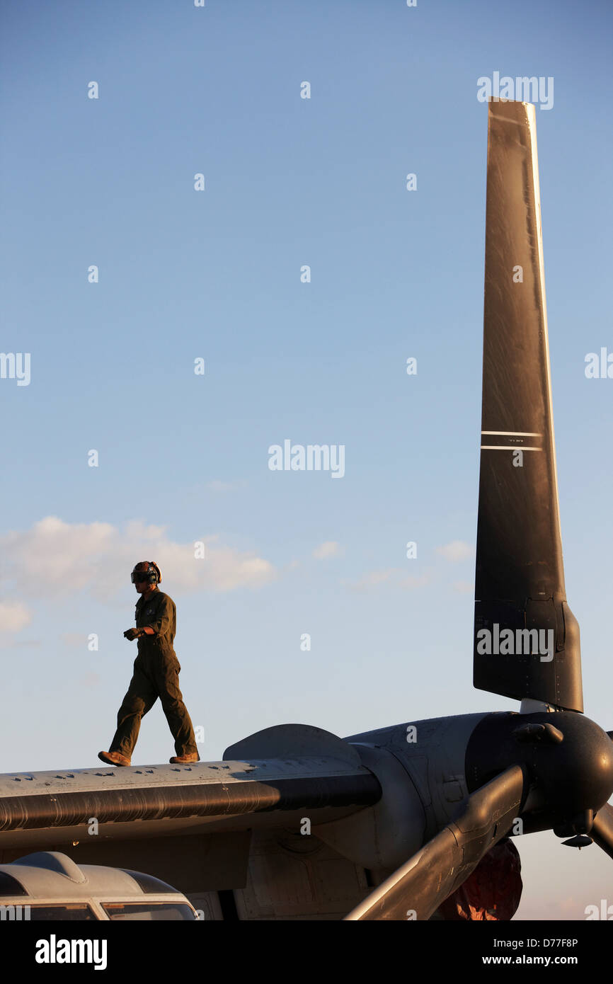 United States Marine Corps aircraft maintenance specialist walks along ...