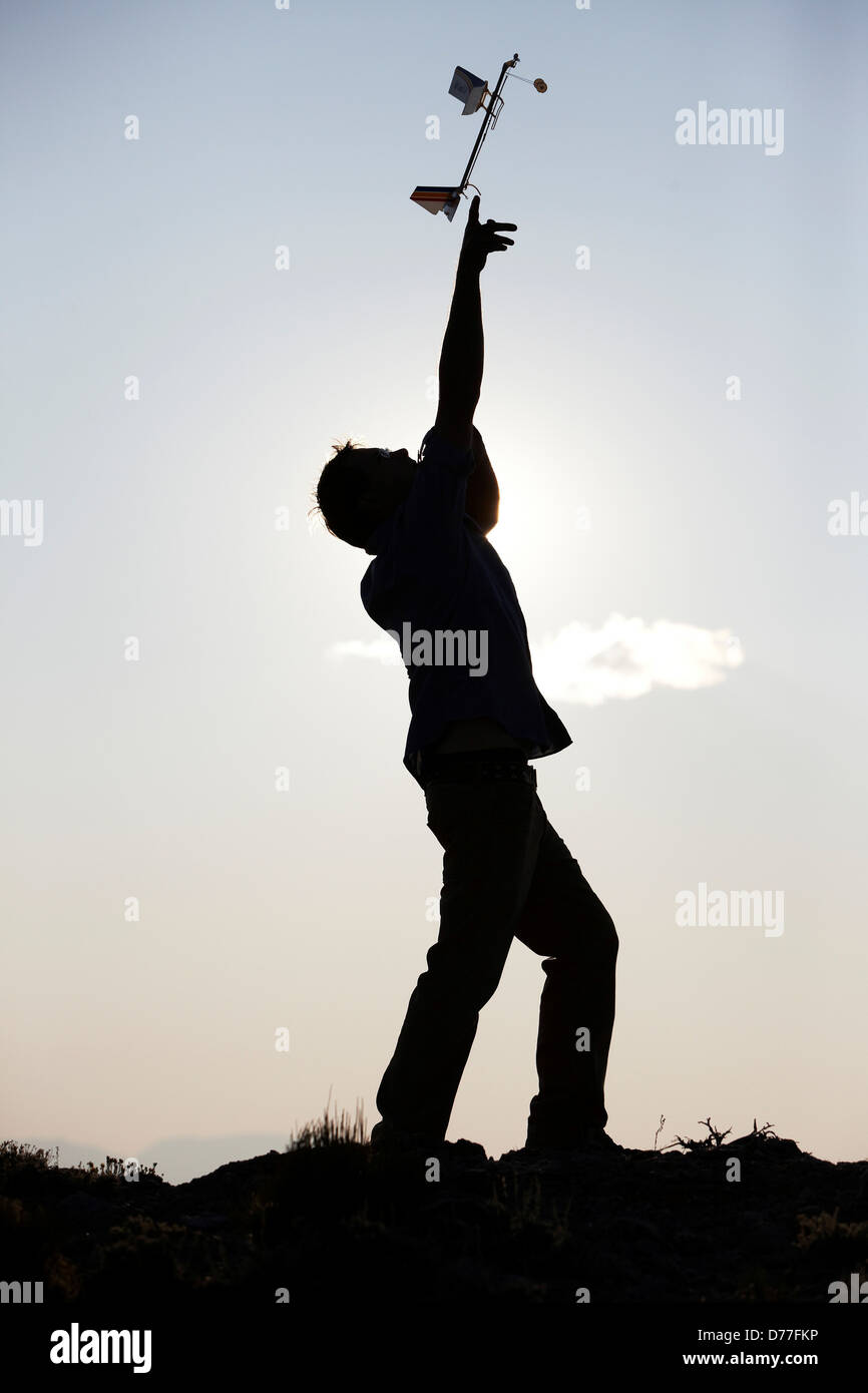 Silhouette man launching rubber-band powered toy airplane Stock Photo ...