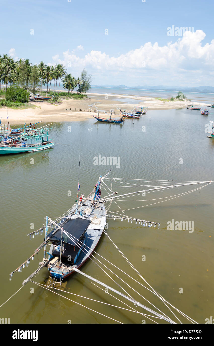 Fishing boats anchored at inlet by the sea in southern Thailand with ...