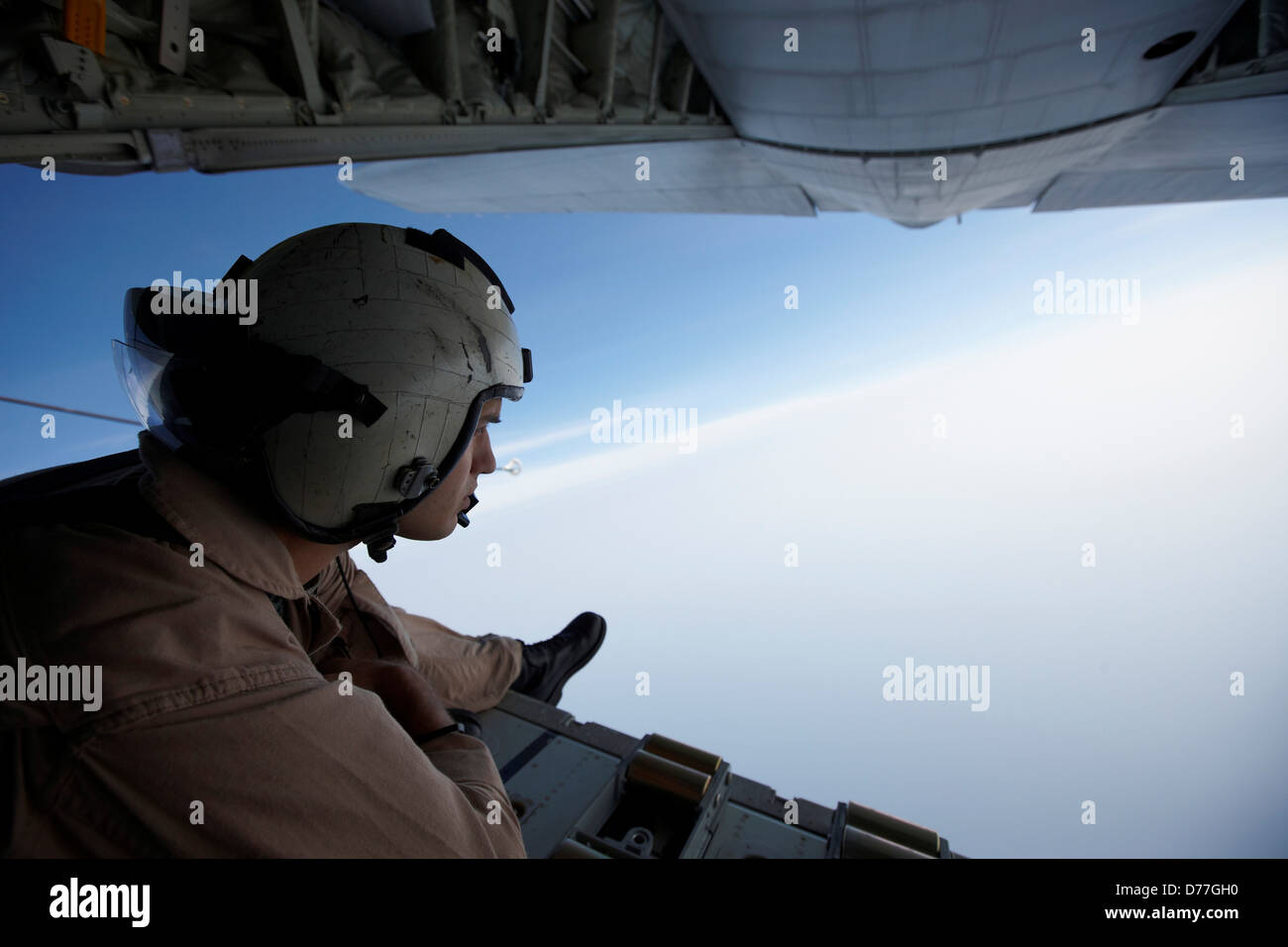 United States Marine Corps aviation crew chief sitting at rear Marine ...