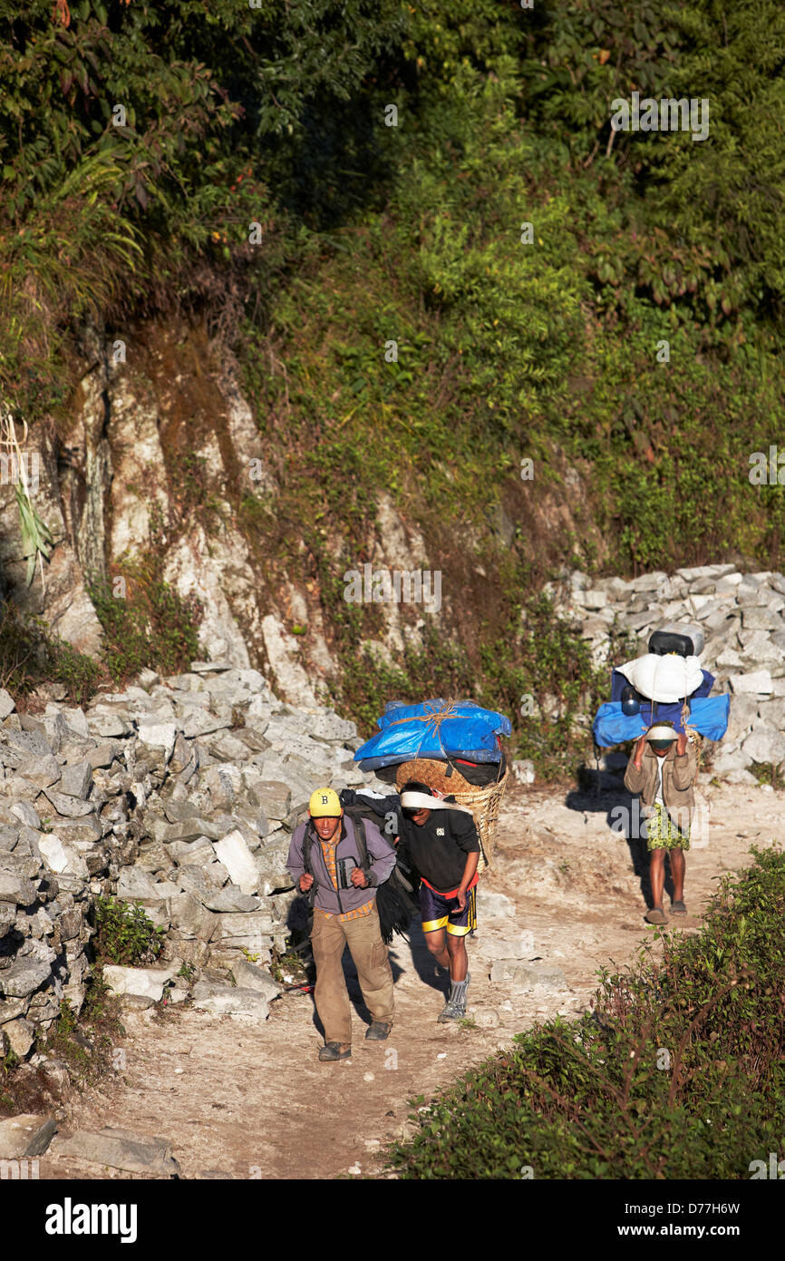 Nepal Nepalese Sherpa porters carrying backpacks Stock Photo - Alamy