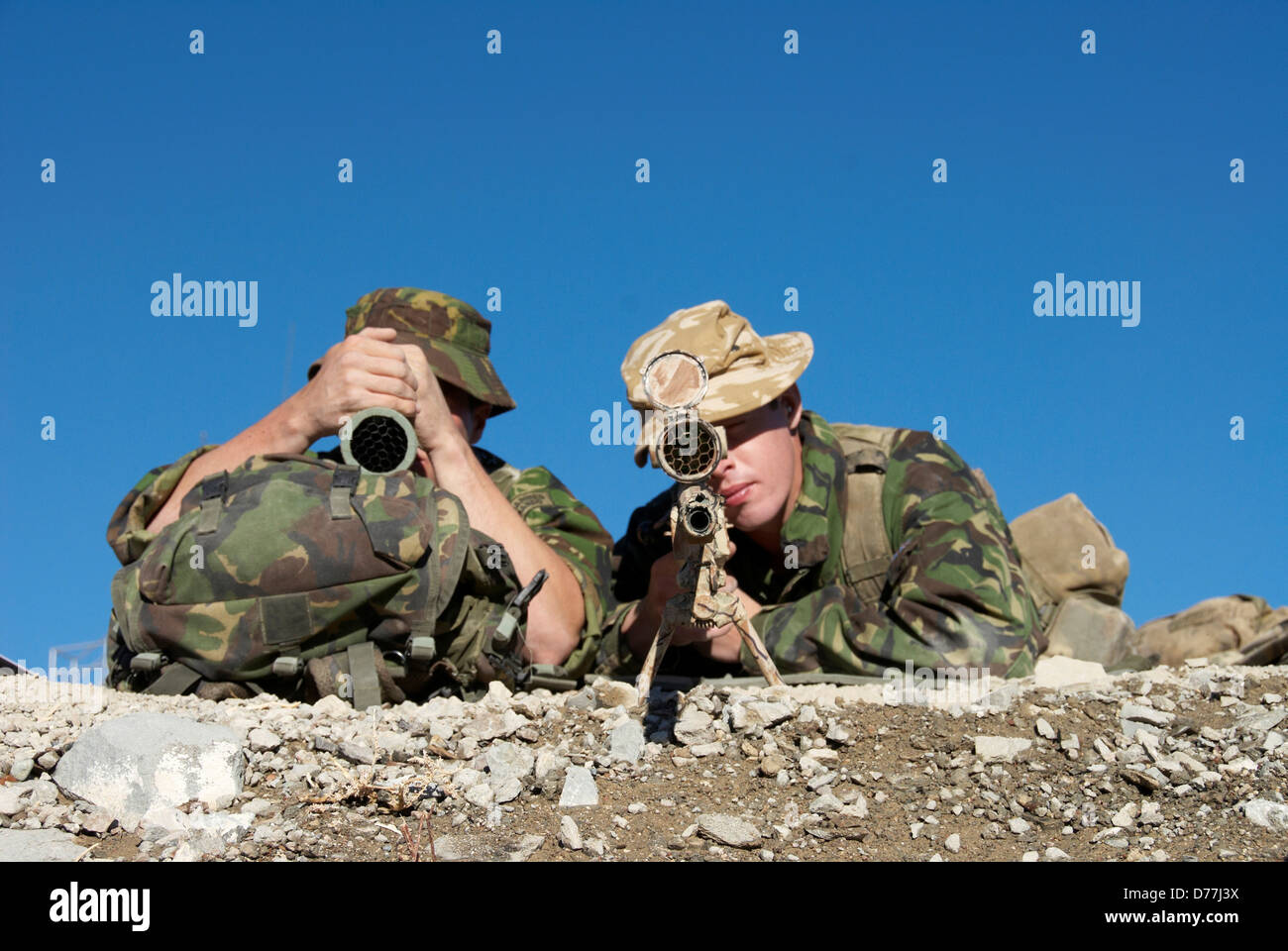 British Royal Marine aiming sniper rifle during mountain sniper ...