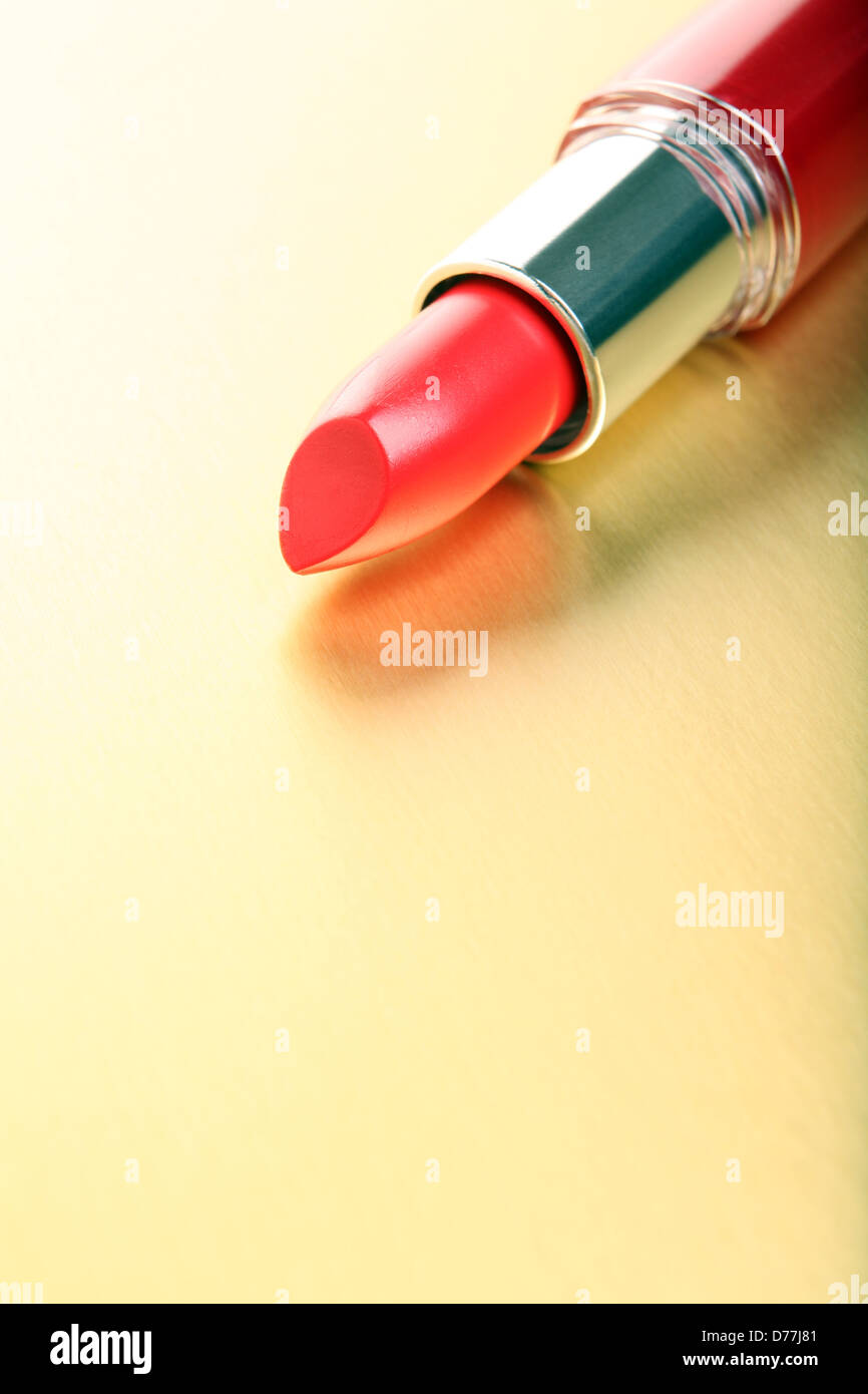 red lipstick closeup on textured golden background Stock Photo - Alamy