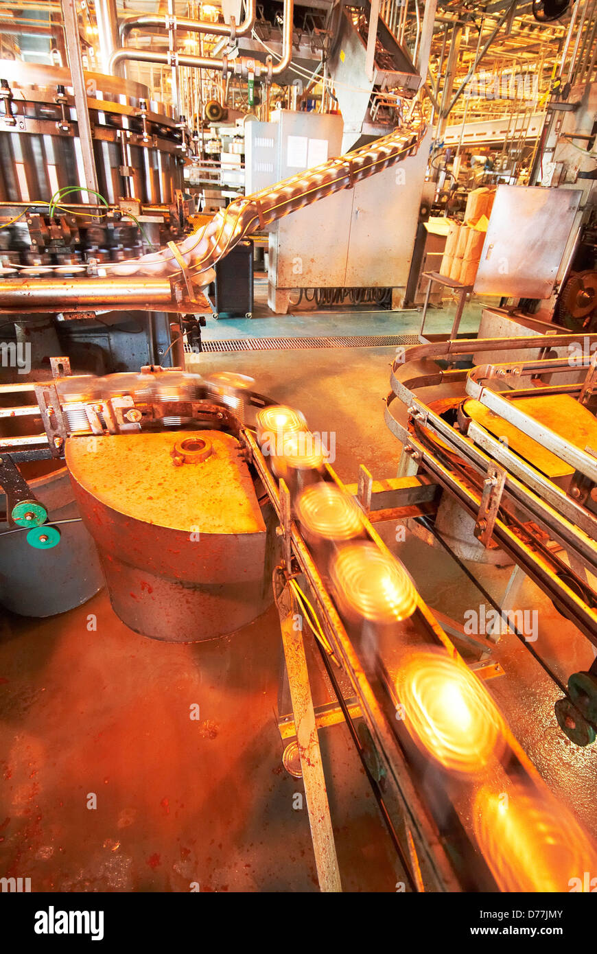 Cans being filled tomato paste at tomato processing plant California ...