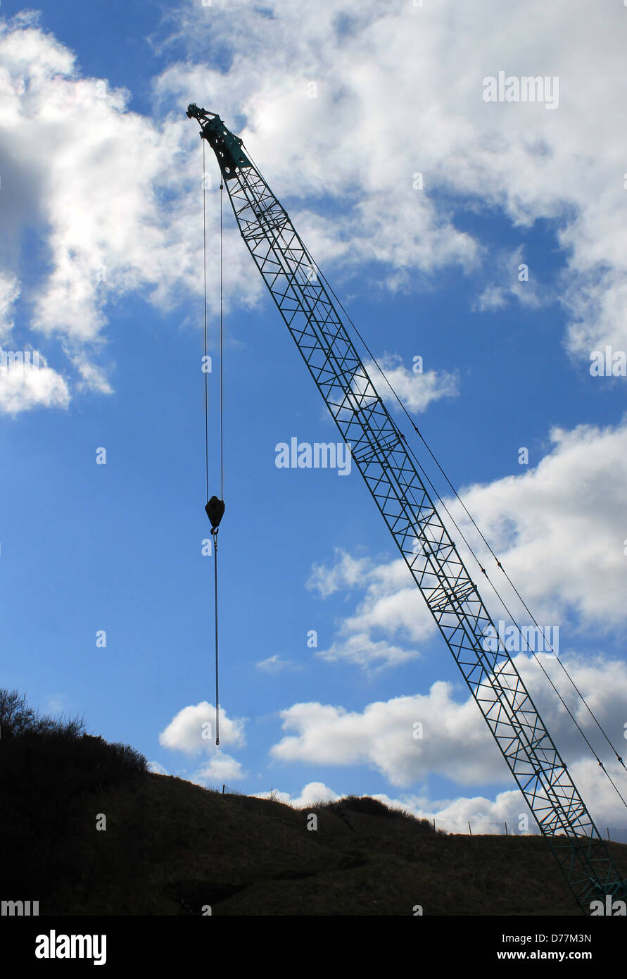 Silhouetted industrial crane with cloudscape background Stock Photo - Alamy
