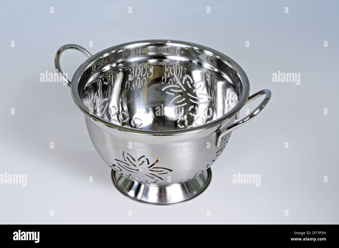 Modern stainless steel colander against a grey background Stock Photo ...