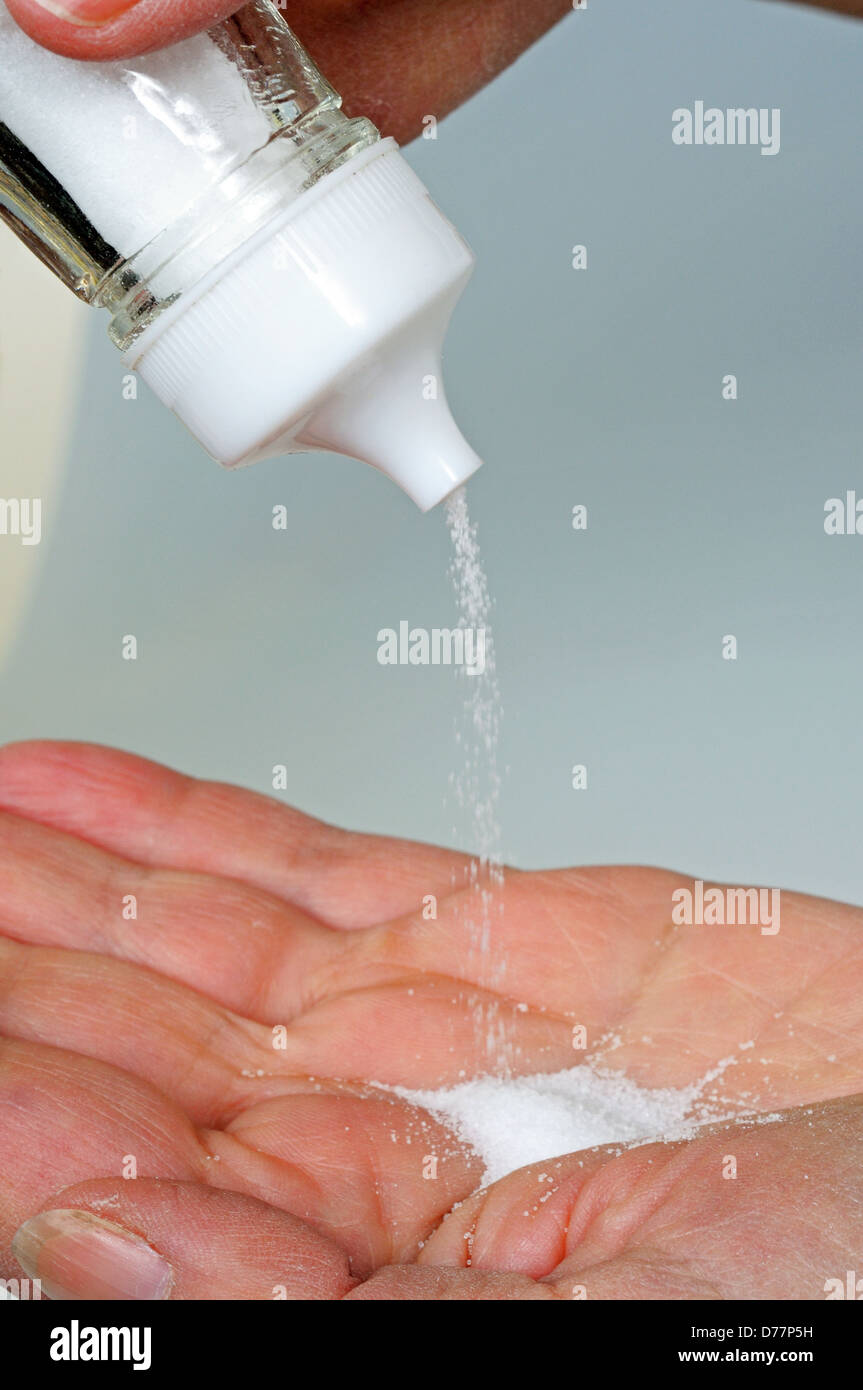 Woman pouring salt hands hi-res stock photography and images - Alamy
