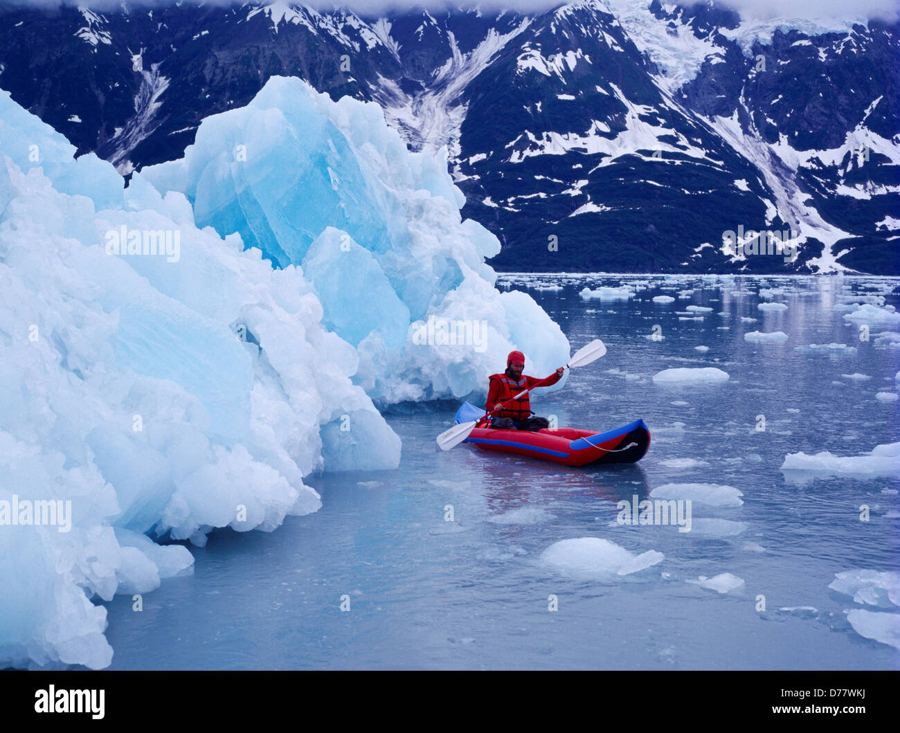 Jeff Gnass paddling inflatable kayak past icebergs calved Hubbard ...