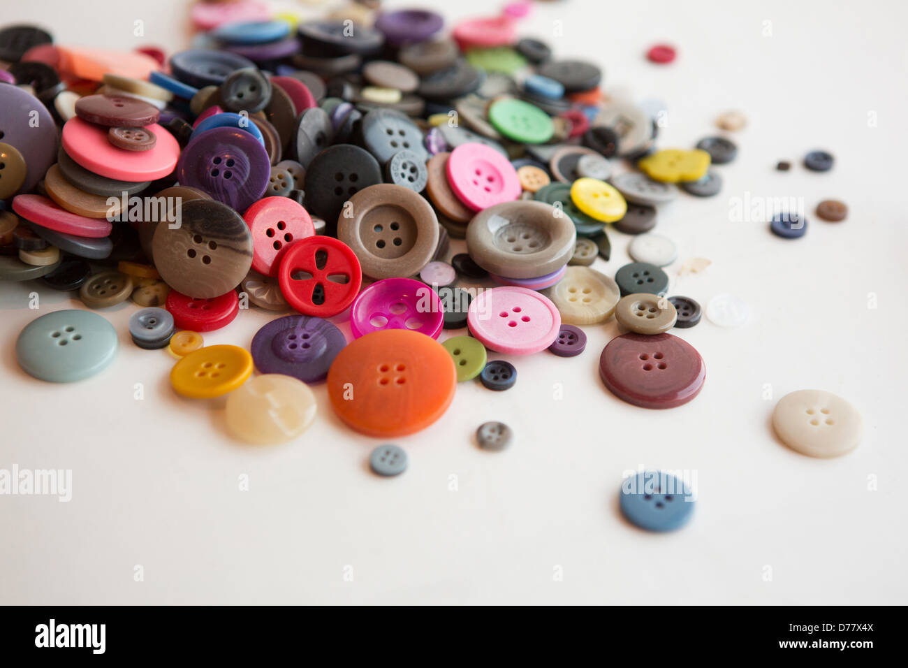 A selection of buttons scattered across a light grey background Stock ...